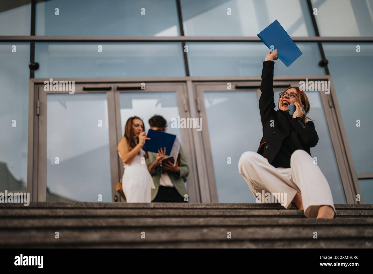 Group of students celebrating success together outside academy building ...