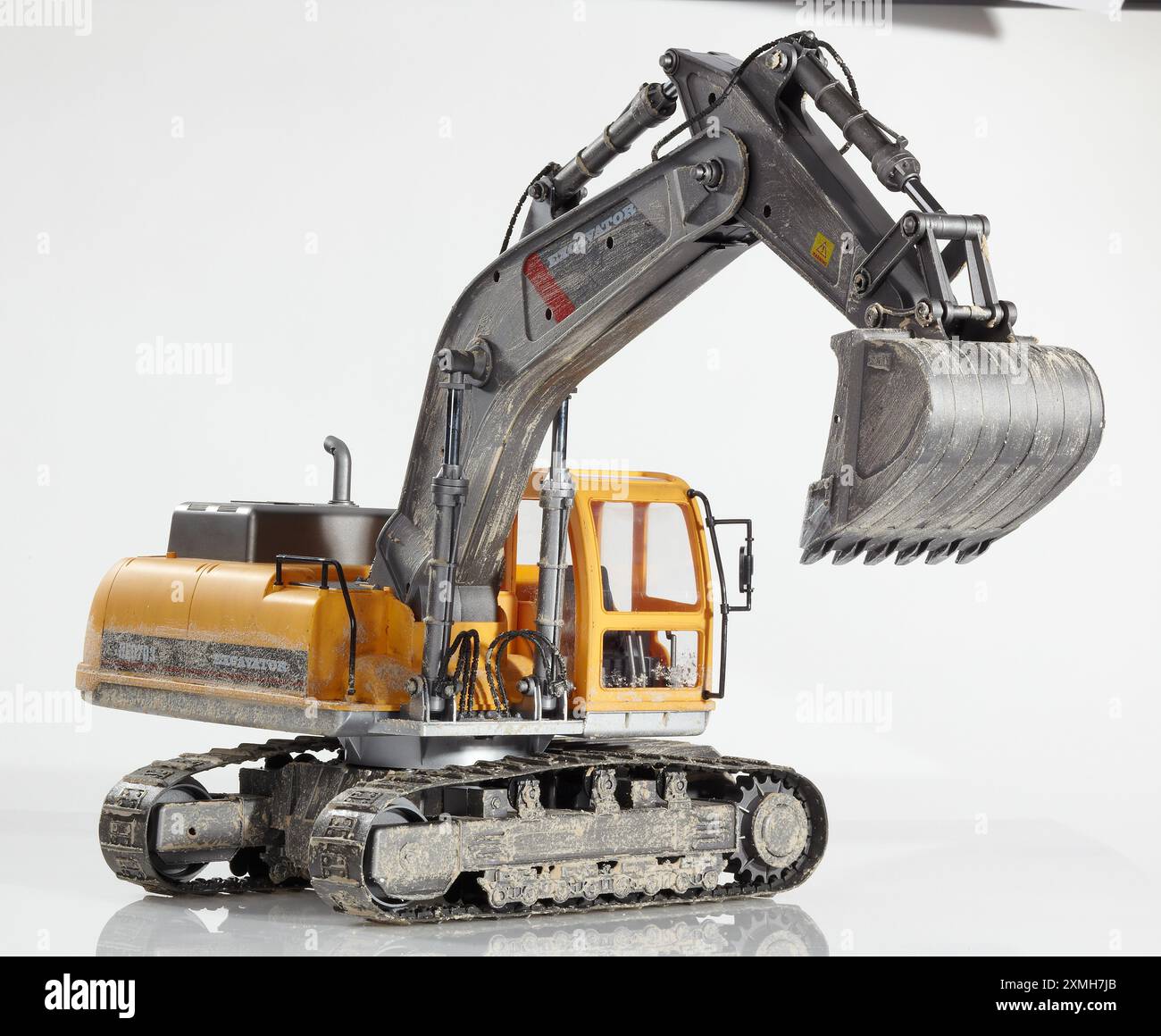 A very realistic yellow scale toy excavator Stock Photo - Alamy