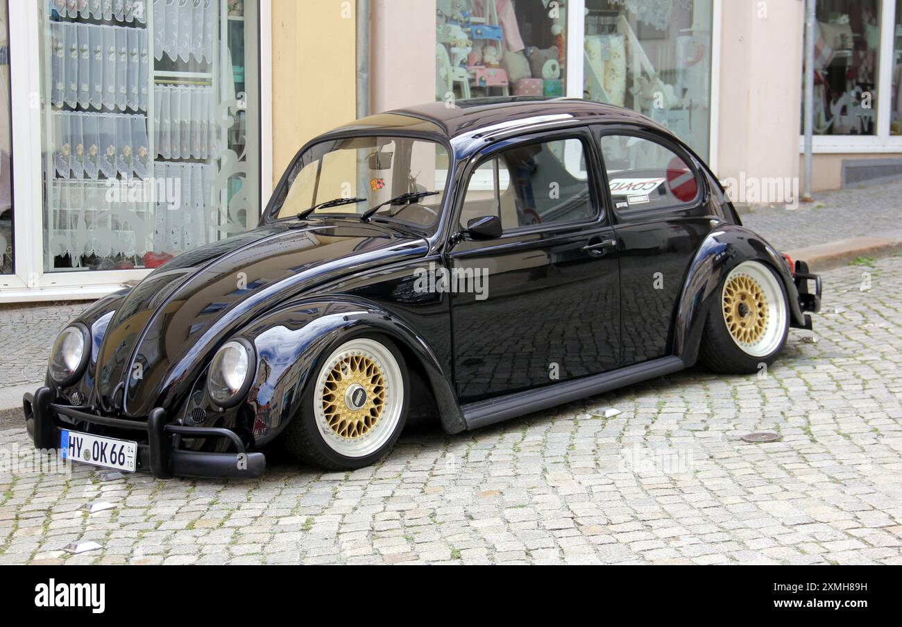 Black VW Beetle, neatly restored and custom tuned-up, parked on a ...