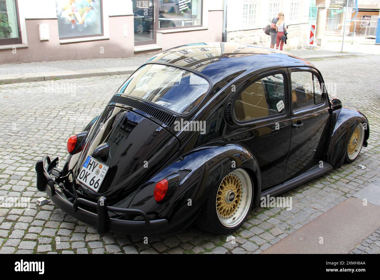 Black VW Beetle, neatly restored and custom tuned-up, parked on a ...