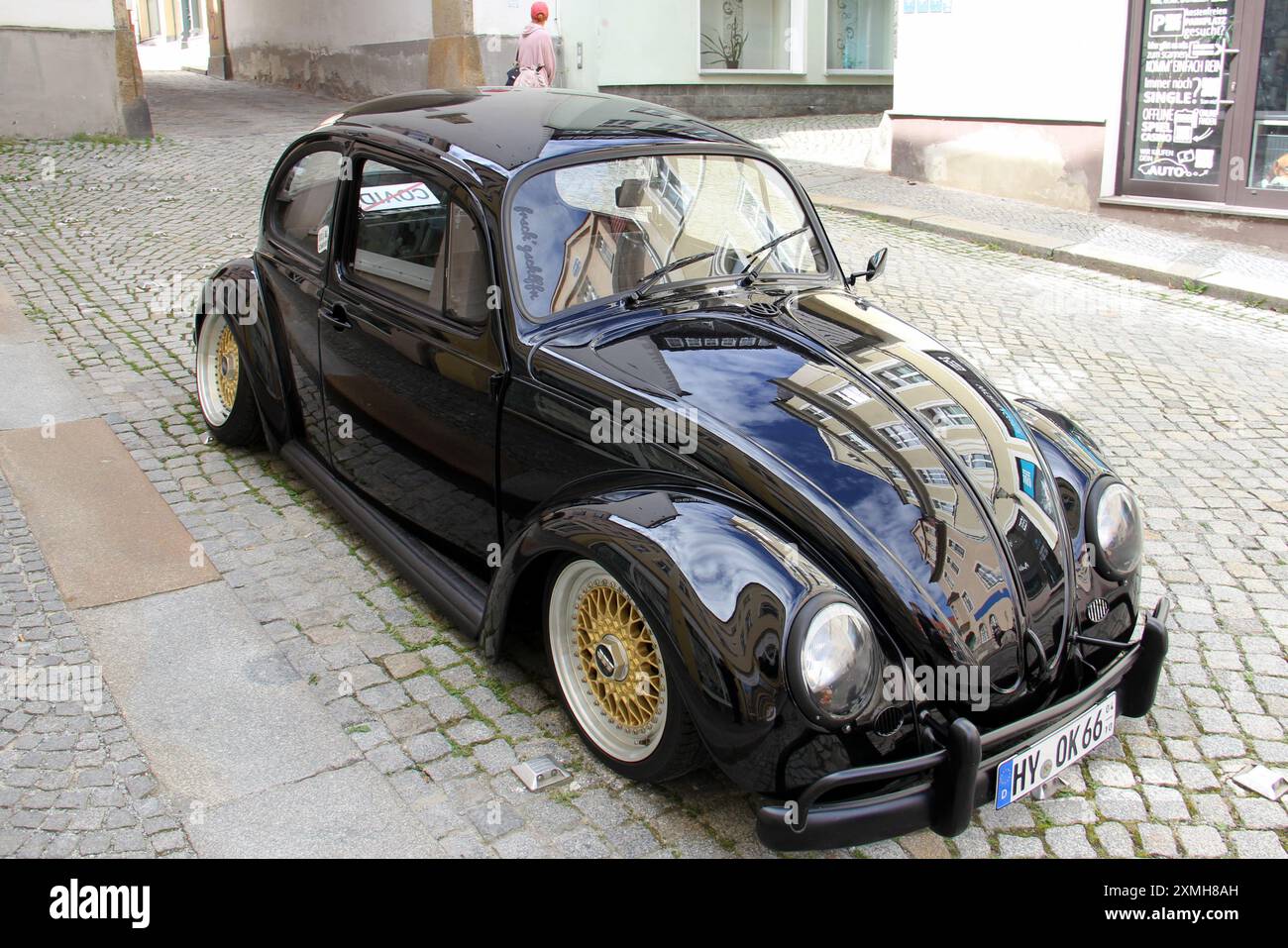 Black VW Beetle, neatly restored and custom tuned-up, parked on a ...