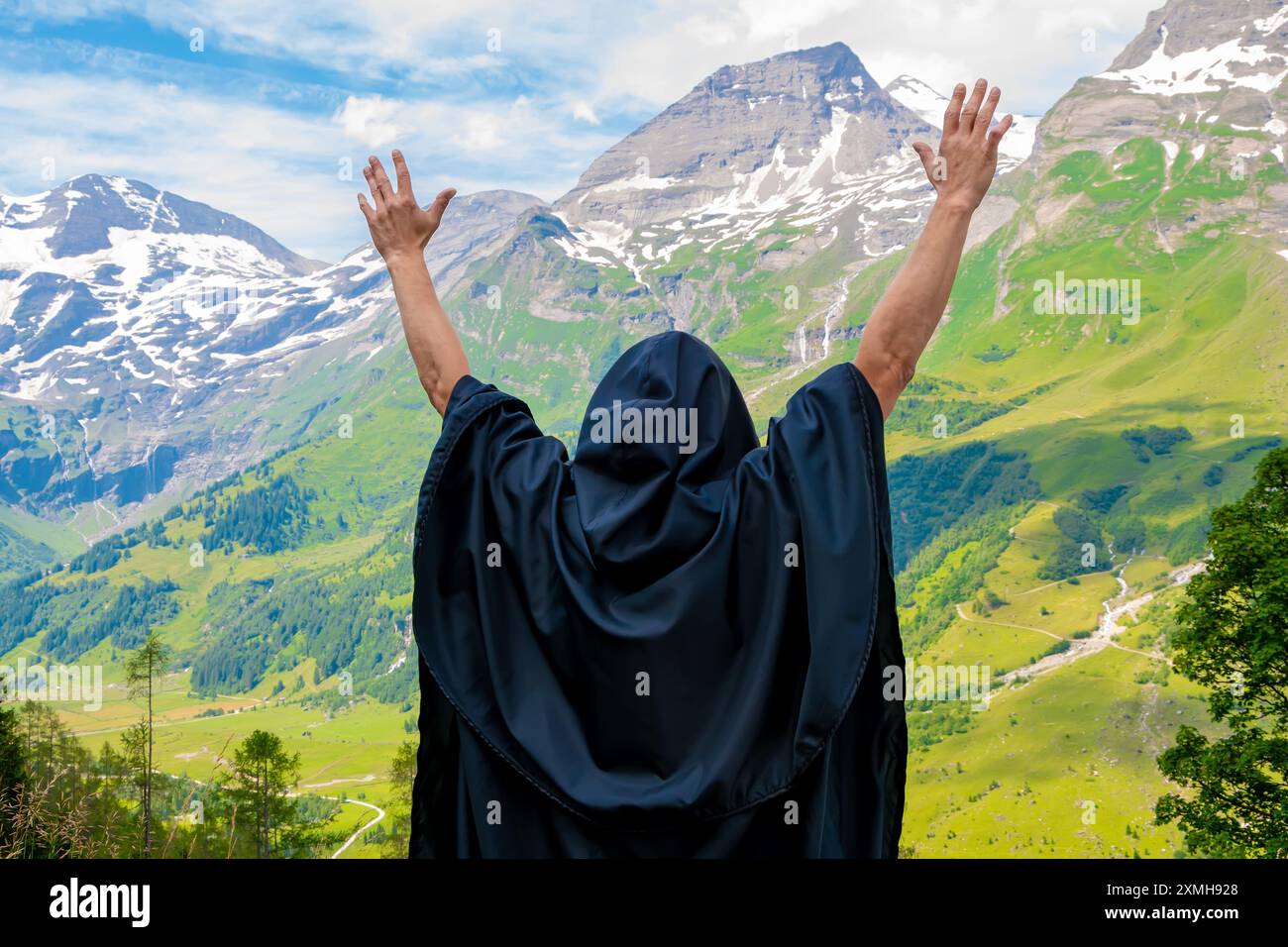 Mystical figure of a male monk embracing nature with outstretched arms ...