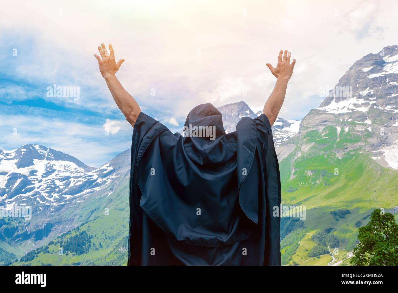 Mystical figure of a male monk embracing nature with outstretched arms ...