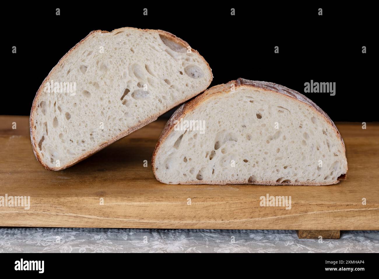 UK. A loaf of freshly baked homemade sourdough bread. The loaf has been ...