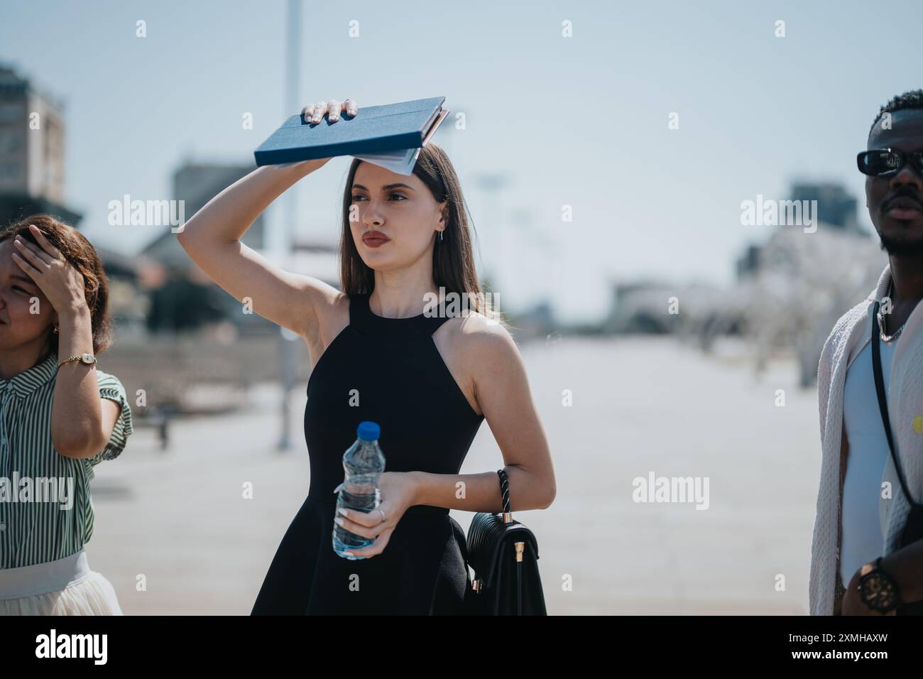 Group of people outdoors in sunny weather using items for shade Stock ...