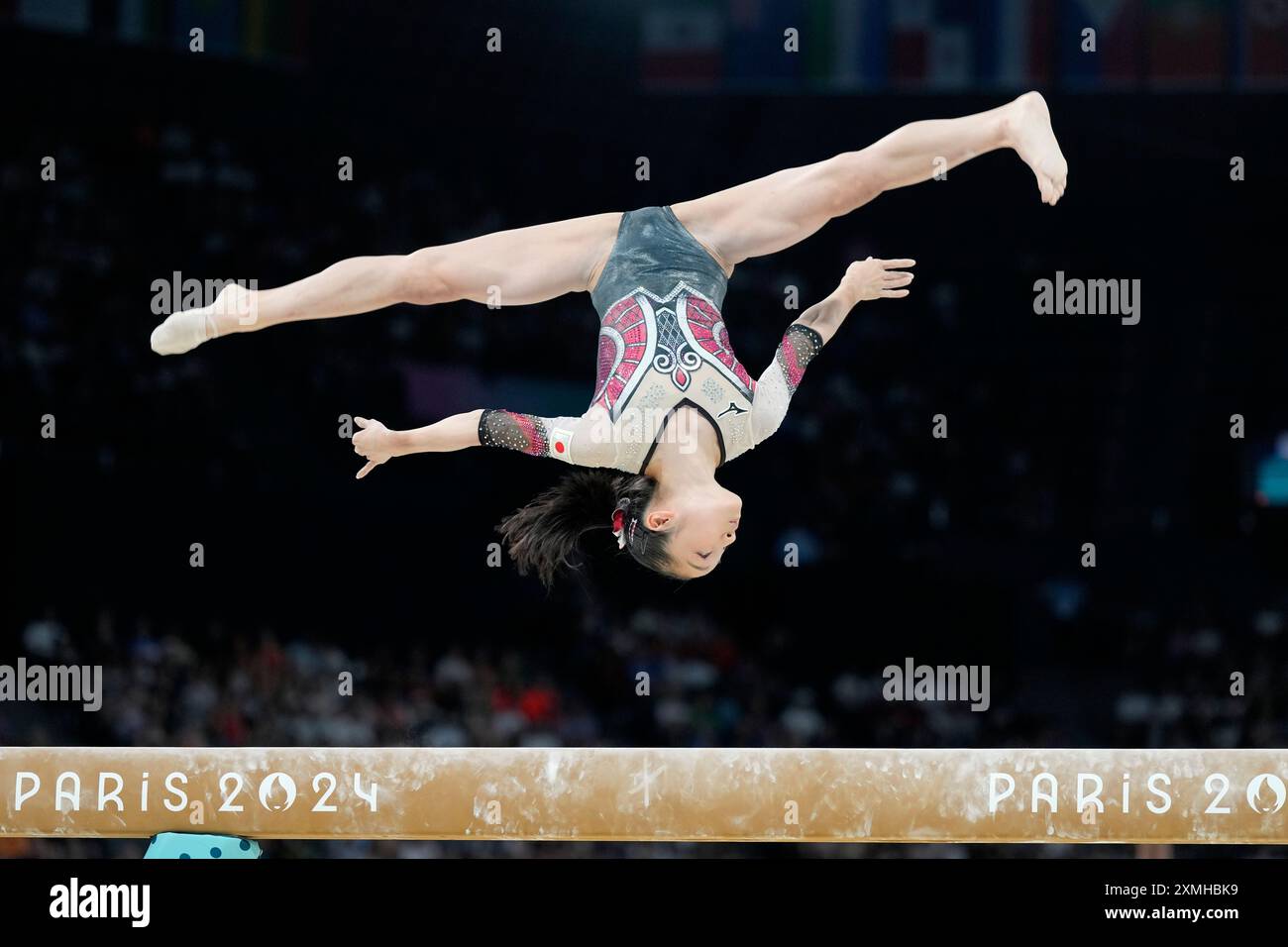 Mana Okamura, of Japan, competes on the balance beam during a women's ...