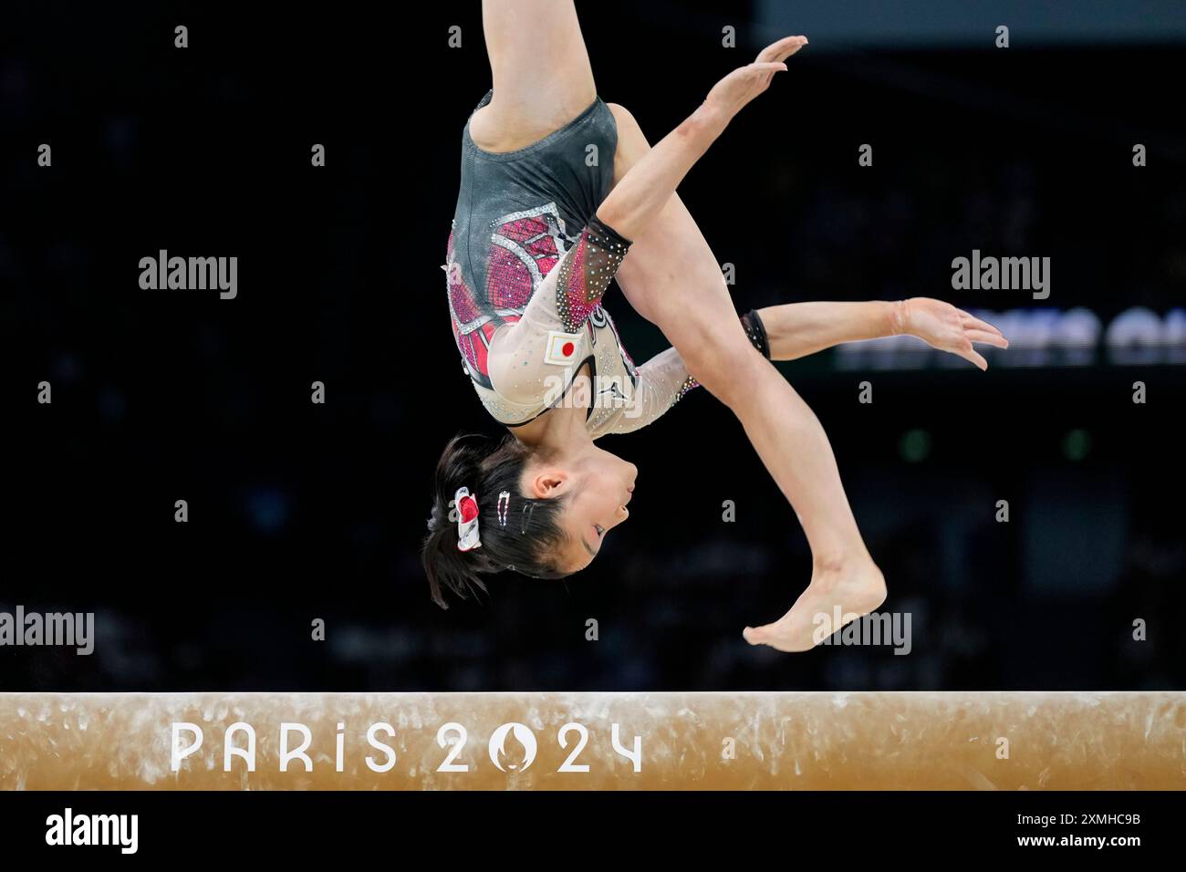 Mana Okamura, of Japan, competres on the balance beam during a women's ...