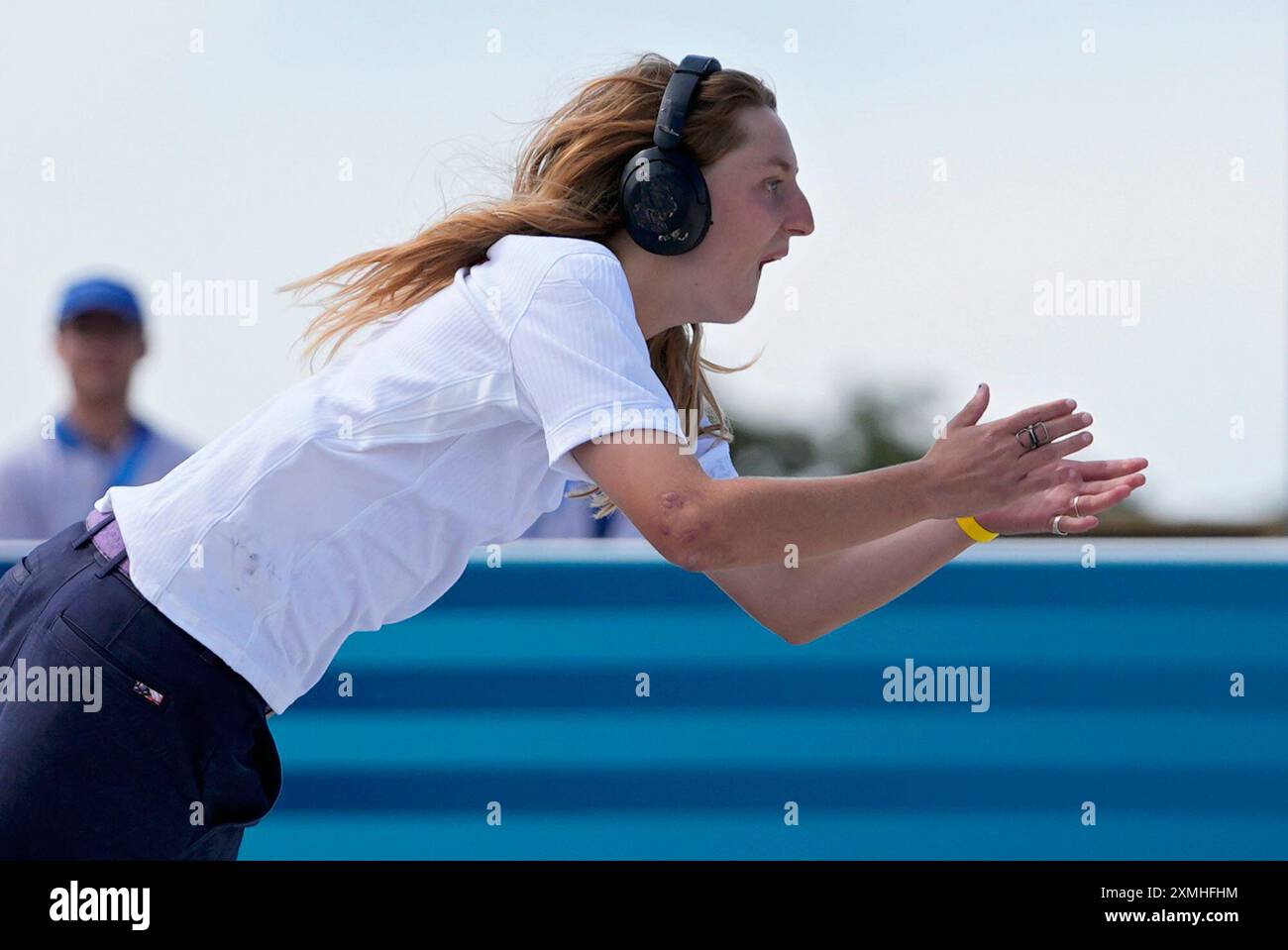 Poe Pinson, of the United States, reacts after landing her last trick ...