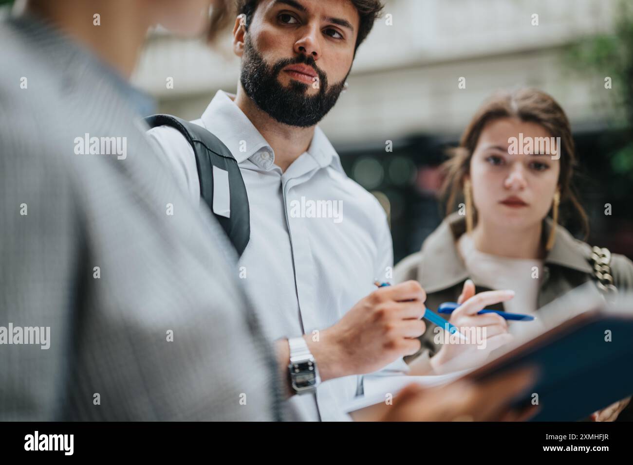 Young business workers brainstorming project ideas in an outdoor ...