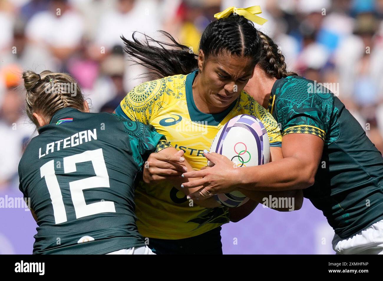 Australia's Sarah Maki is tackled by South Africa's Liske Lategan, left ...