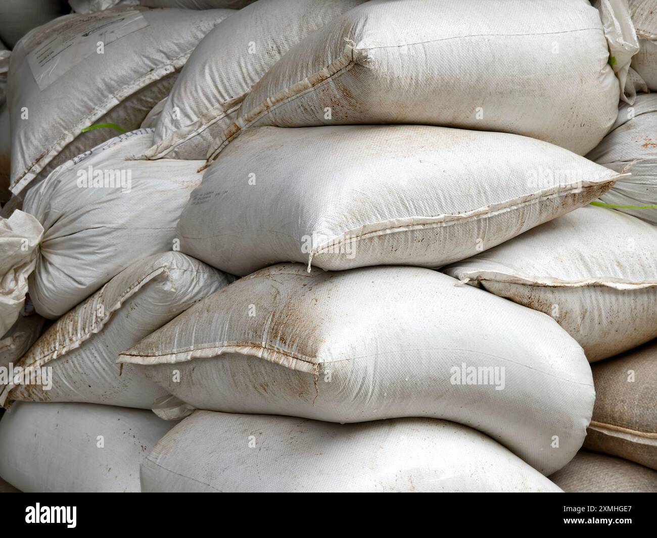 Stacking of big white bags in the modern warehouse Stock Photo - Alamy
