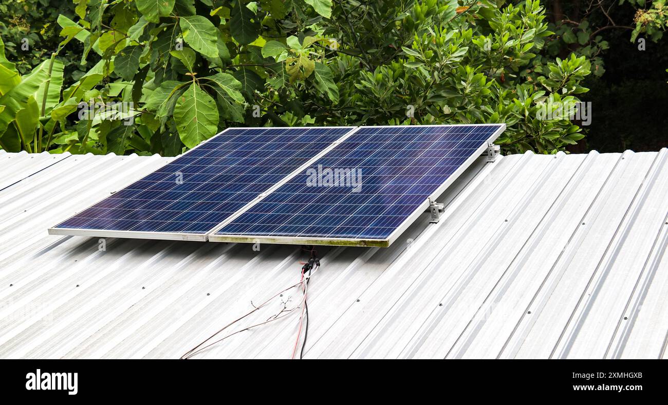 Solar cell panels installed on a metal sheet roof, emphasizing the ...
