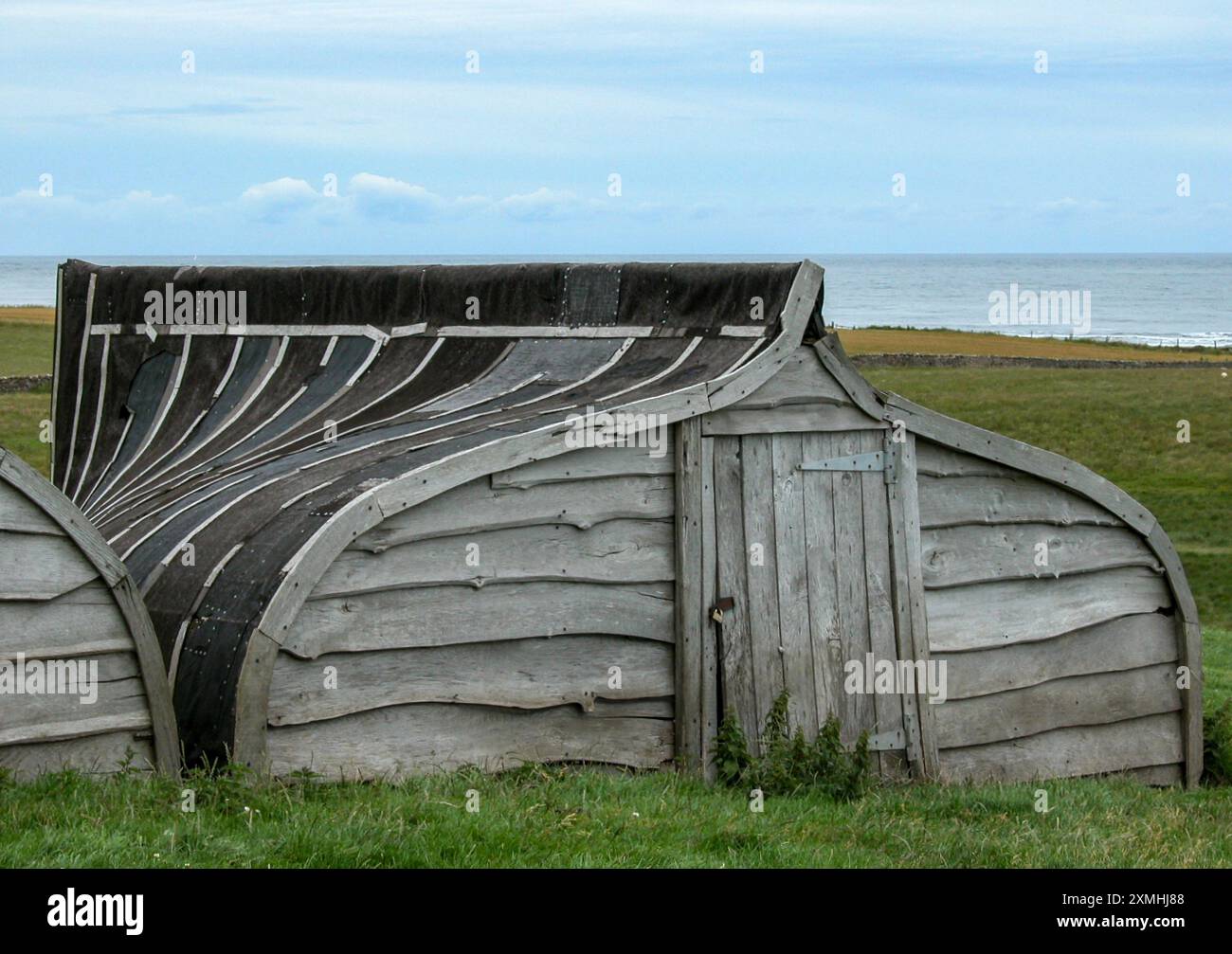 Upturned hull of a ship on land turned into a fishing shed Stock Photo ...