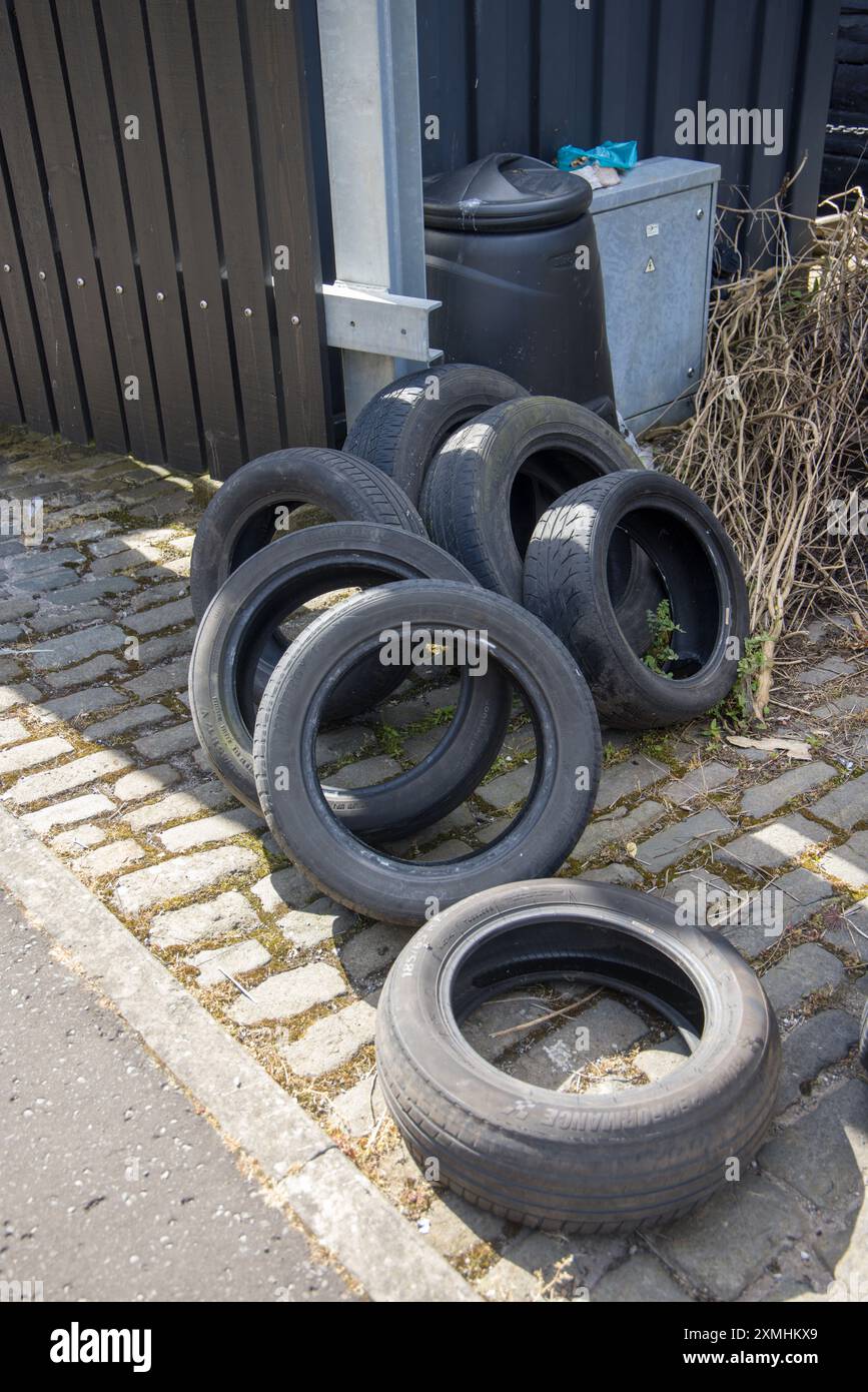 Old rubber car tyres / tires lying around outside near a shed ...