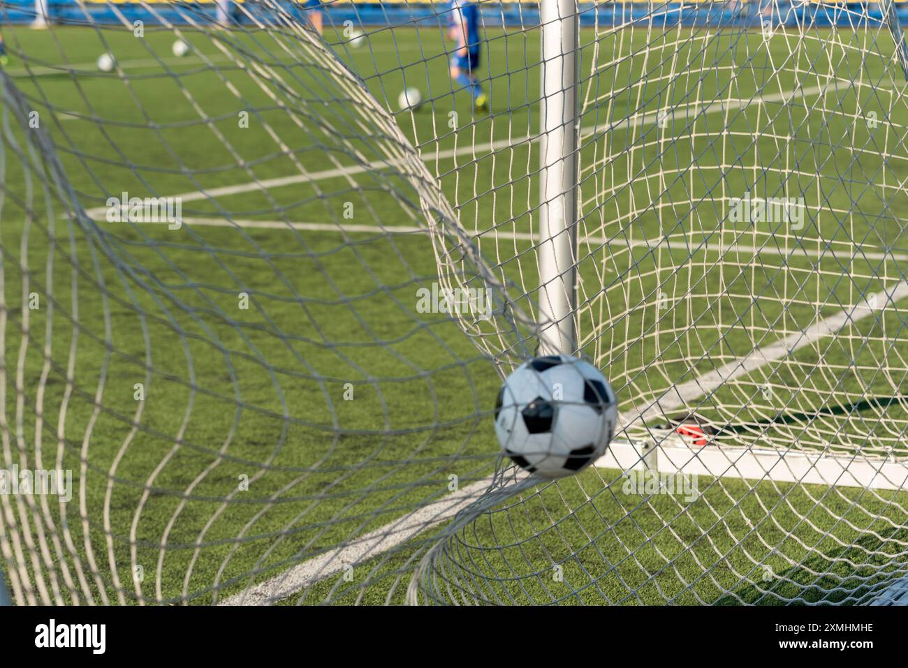 A black and white soccer ball propelled by a powerful shot, tearing ...