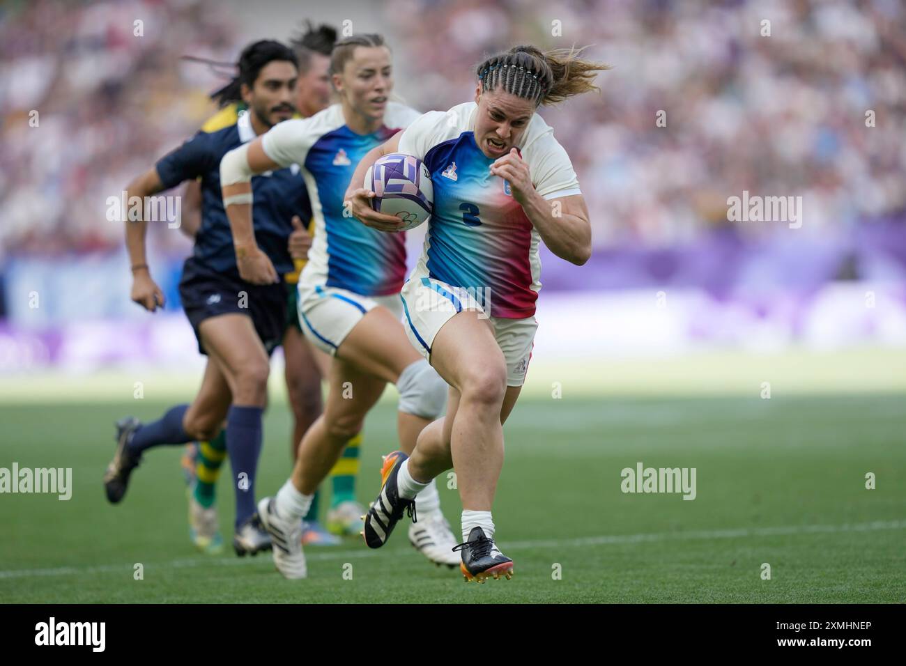 Chloe Belle of France charges forward as she runs onto score a try ...
