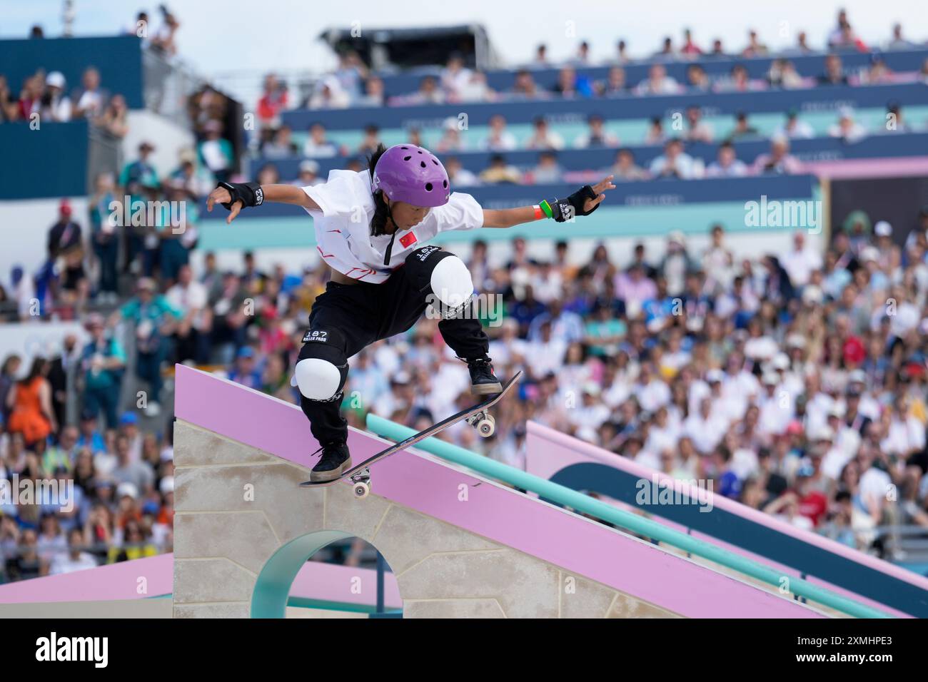 Cui Chenxi, of China, executes a trick during the women's skateboard ...