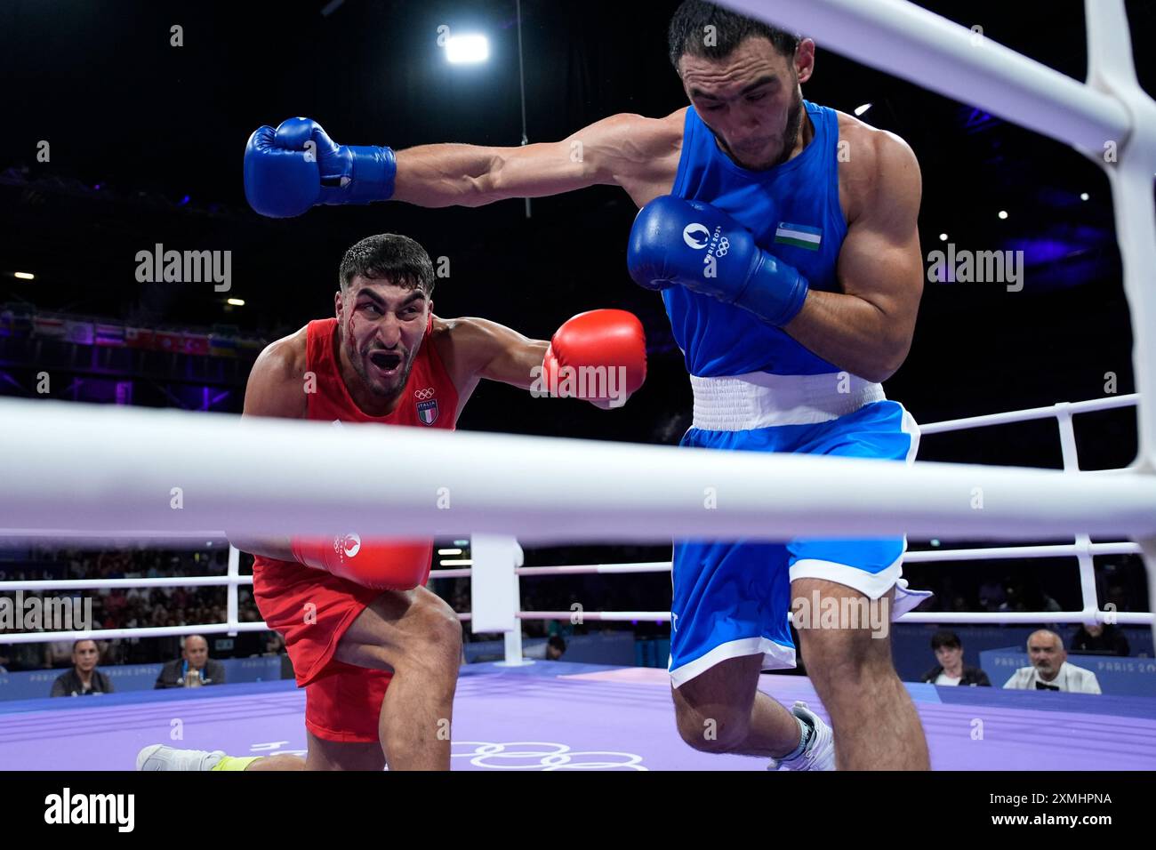 Italy's Aziz Mouhiidine, red, fights Uzbekistan's Lazizbek Mullojonov ...