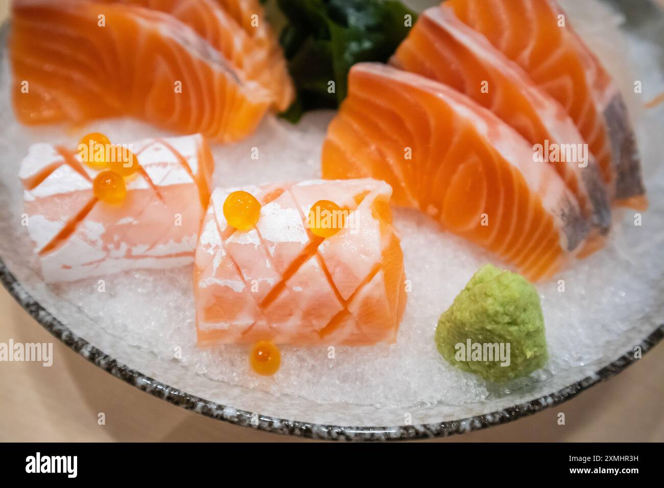 Fresh salmon slice sashimi serve on ice with wasabi Japanese style ...