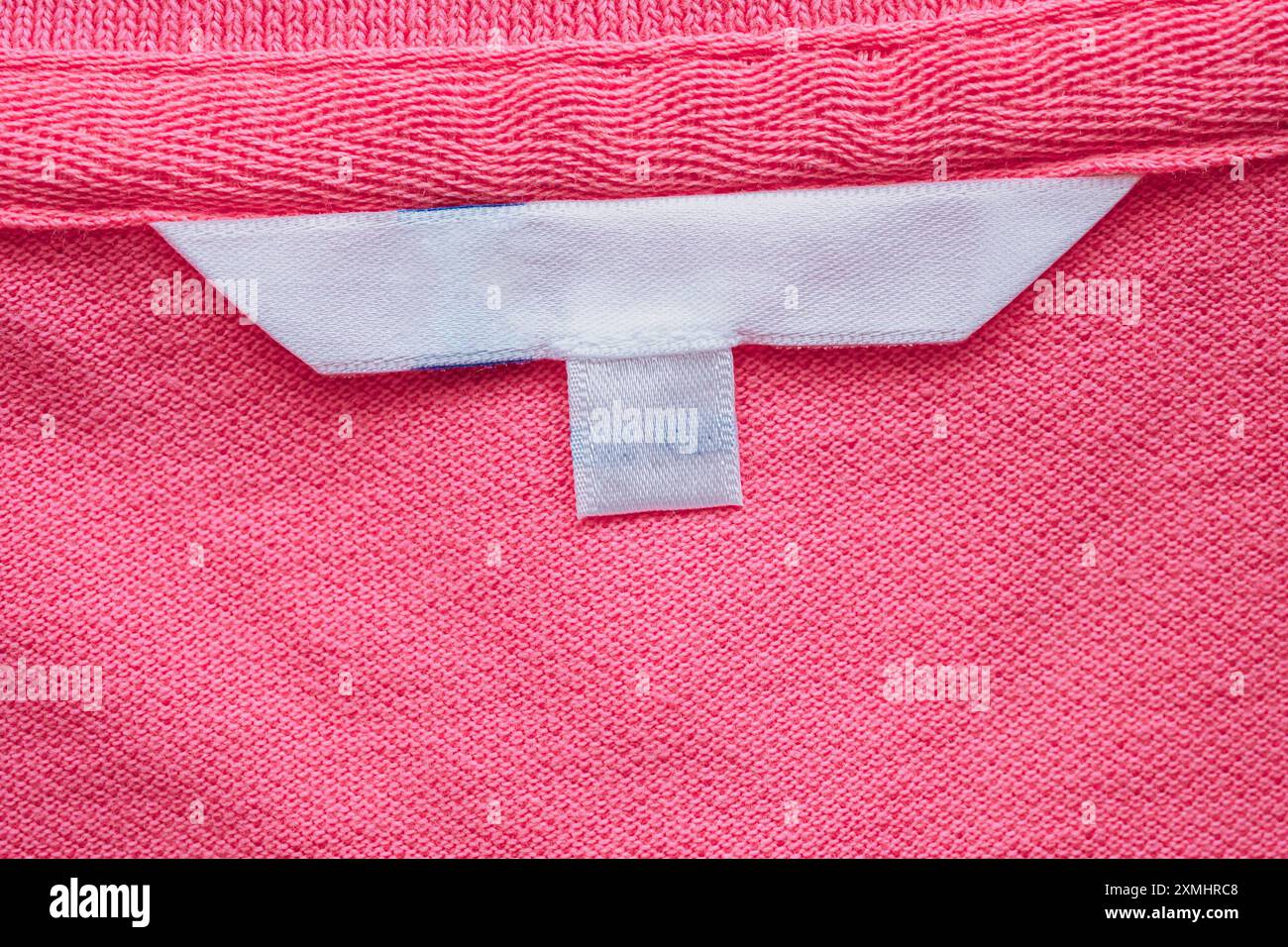 Blank white clothes label on new shirt Stock Photo - Alamy