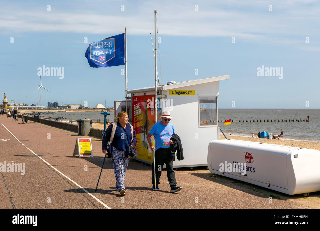 People walking with sticks past Lifeguards station on the Esplanade ...