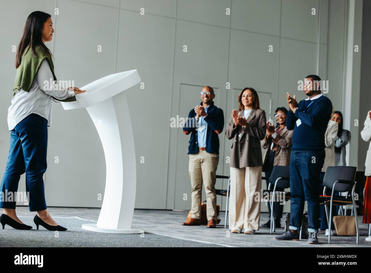 Female leader delivering a business presentation at a conference ...