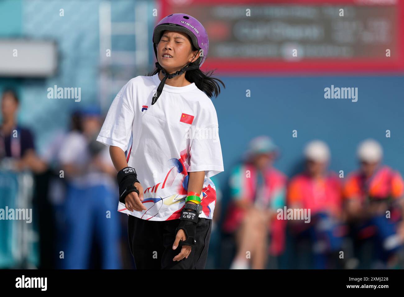 Cui Chenxi, of China, reacts after crashing during the women's skateboard street final at the ...