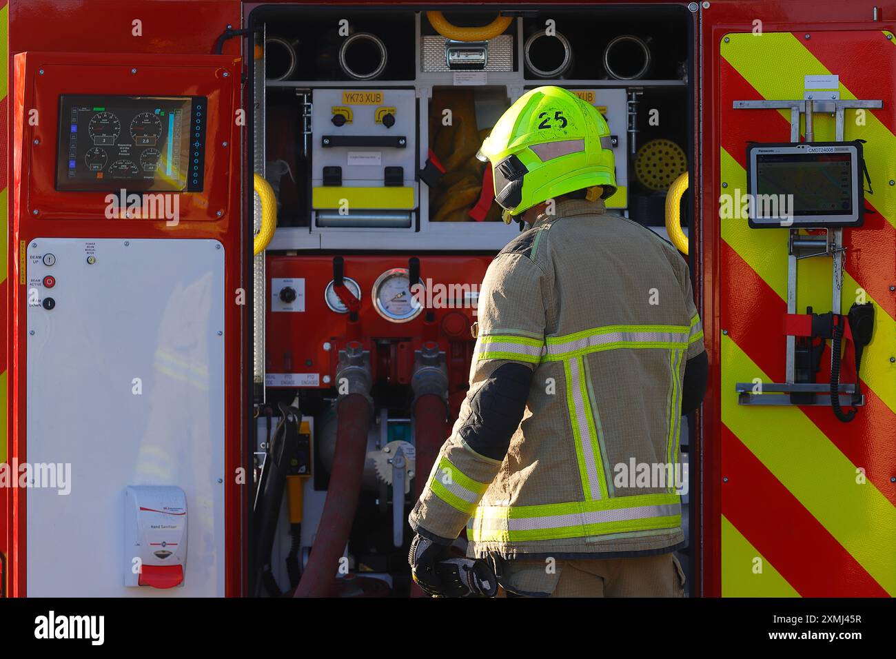 A firefighter from West Yorkshire Fire & Rescue attends to a pump at an ...
