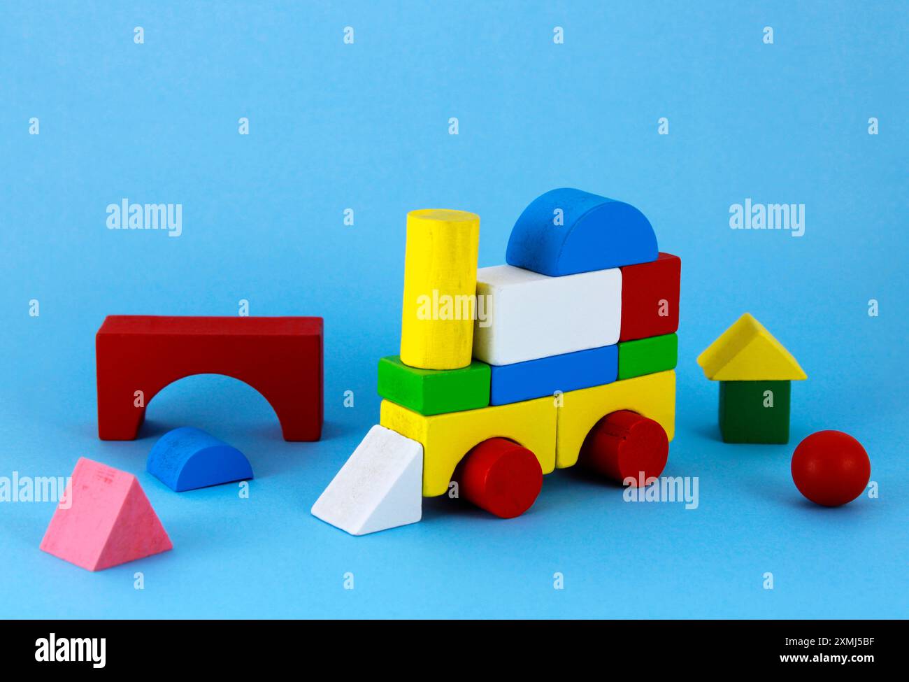 Train made of colorful wooden figures Stock Photo - Alamy