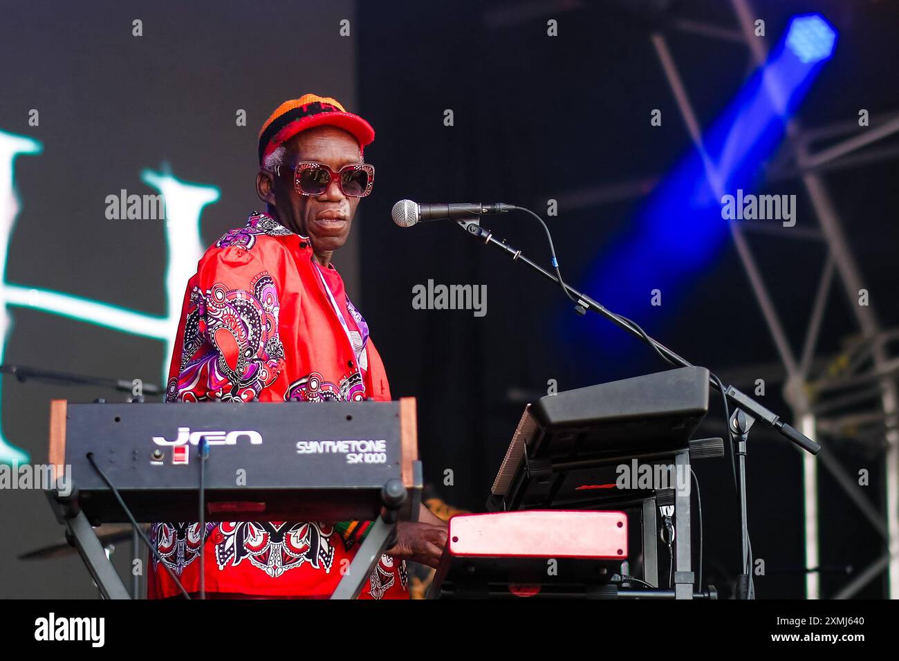 Malmesbury, UK. 28th July, 2024. Patrick Mwondela of WITCH as the bad ...