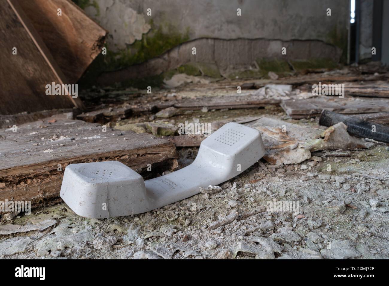 Broken vintage phone handset on floor, abandoned messy office building ...