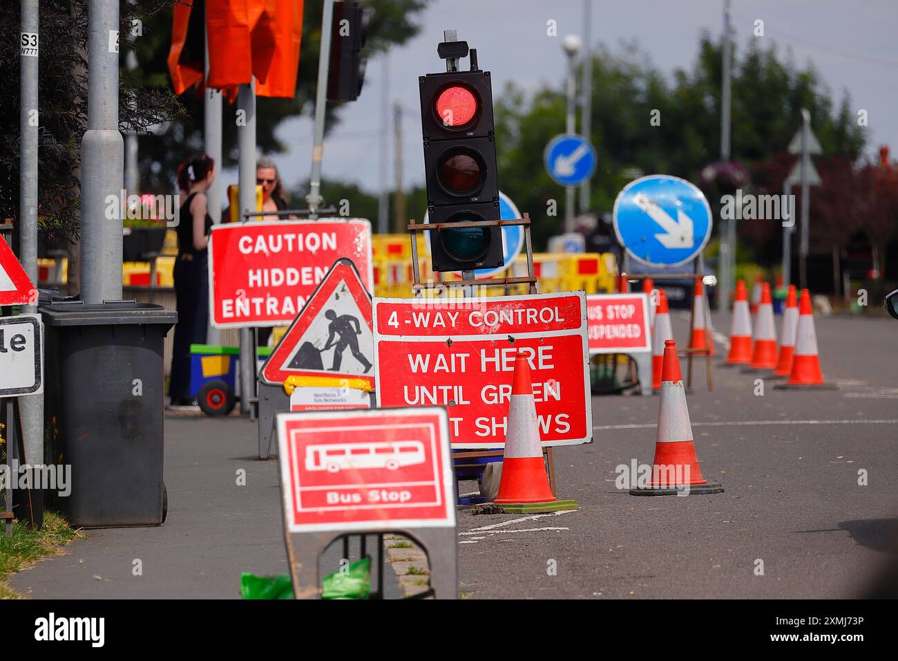 Roadworks signs and temporary traffic lights Stock Photo - Alamy