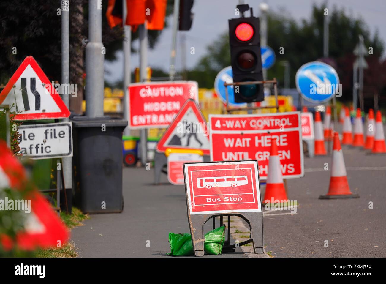 Roadworks signs and temporary traffic lights Stock Photo - Alamy