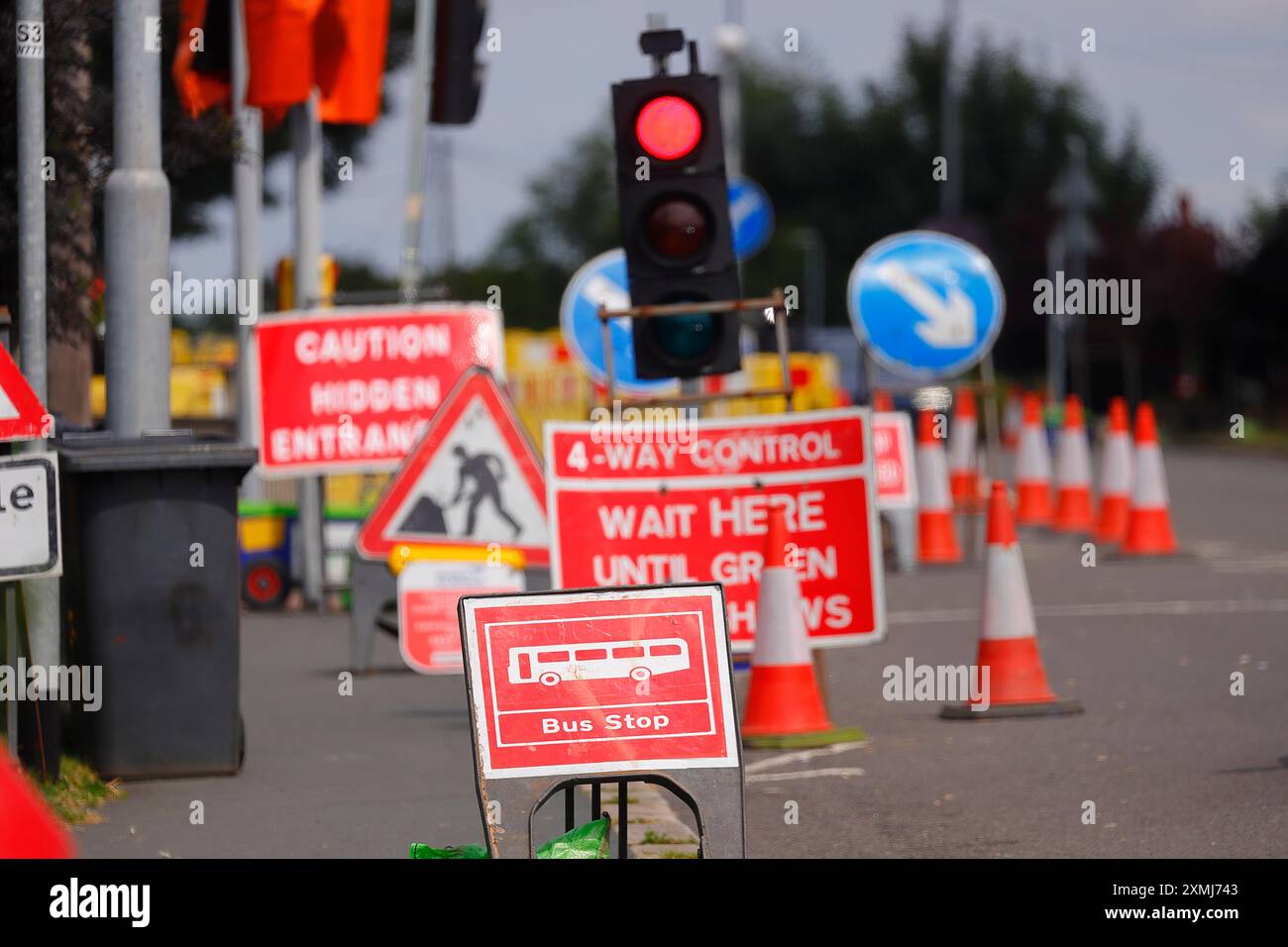Roadworks signs and temporary traffic lights Stock Photo - Alamy