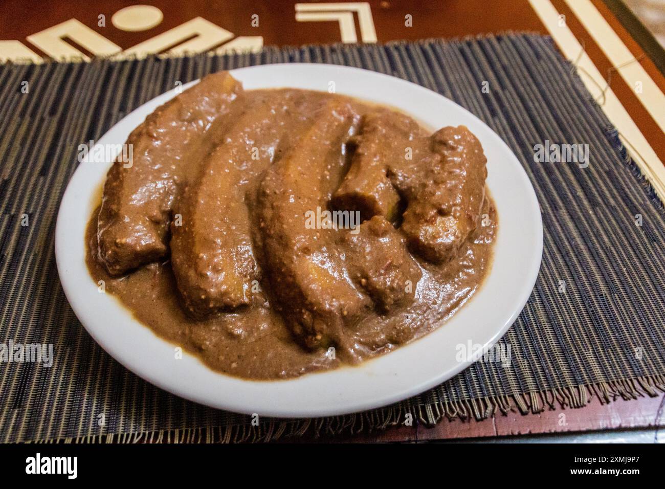 Matoke bananas in groudnut (peanut) sauce, meal in Uganda Stock Photo ...