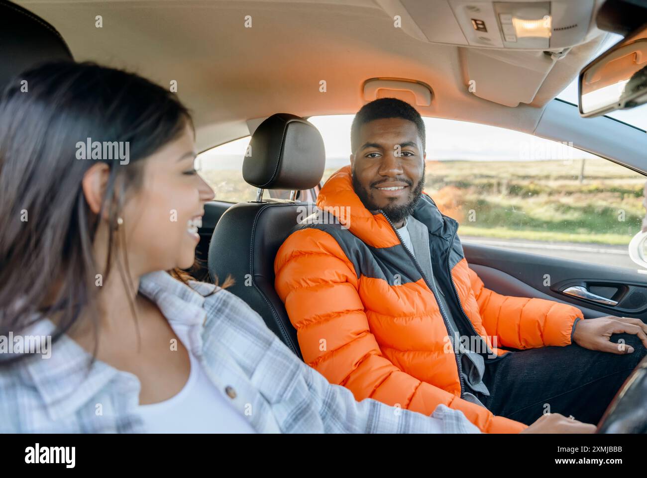 Beautiful happy young loving couple holding hands and smiling while ...