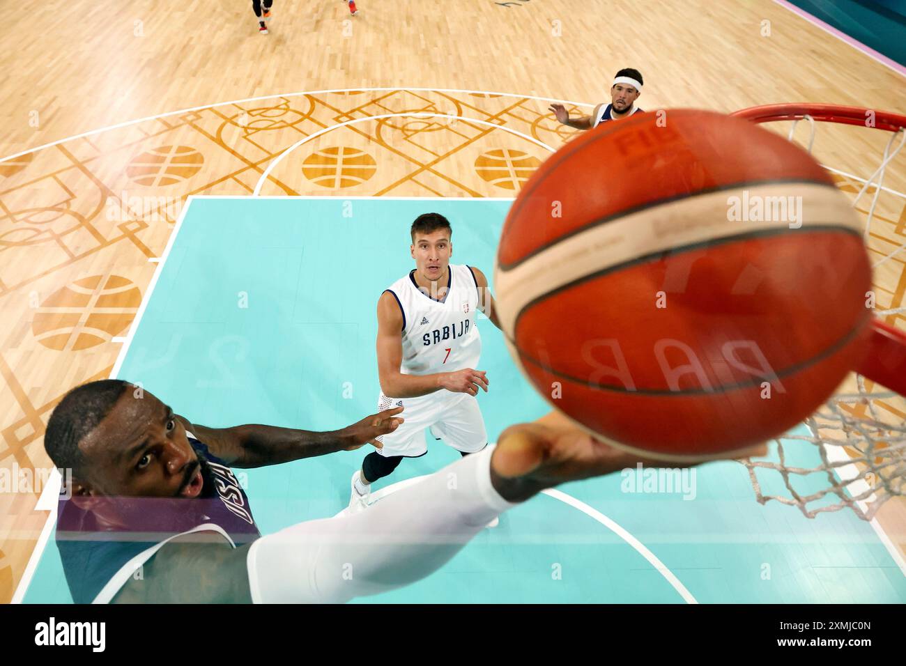 LeBron James, left, of the United States, shoots as Bogdan Bogdanovic ...