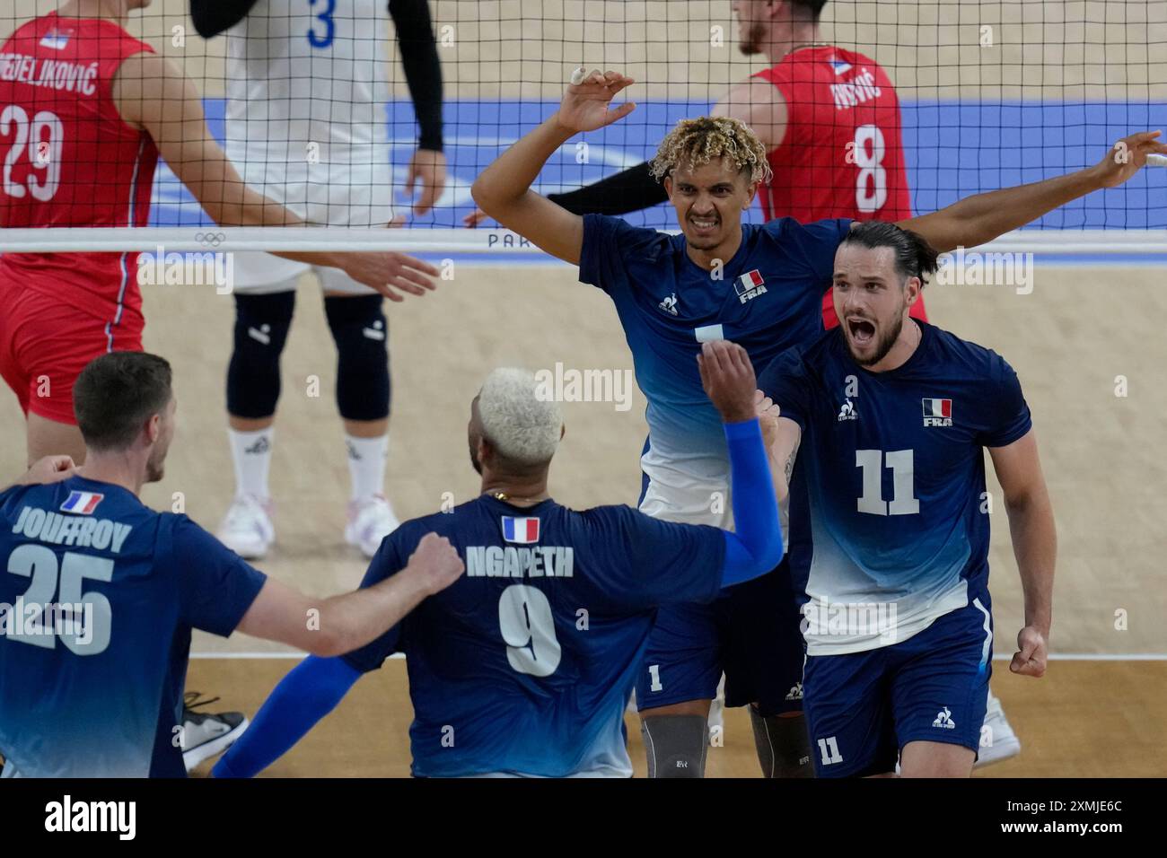 France's players celebrate a point during the group A men's volleyball ...