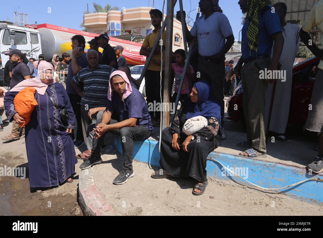 Palestinian patients carry their bags and wait to board buses in the ...