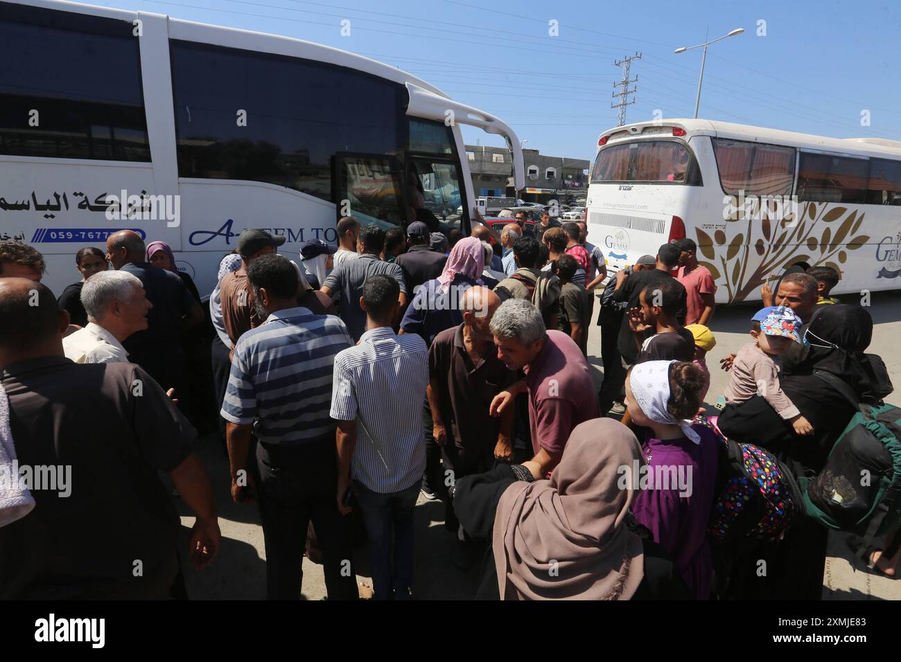 Palestinian patients carry their bags and wait to board buses in the ...