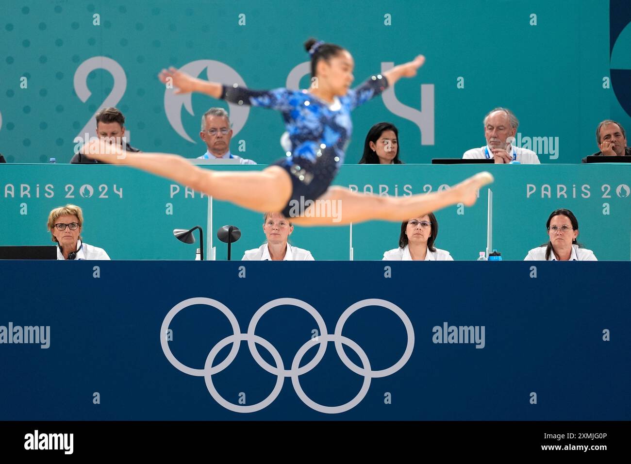 Olympic officials watch Aurelie Tran, of Canada, perform her floor ...