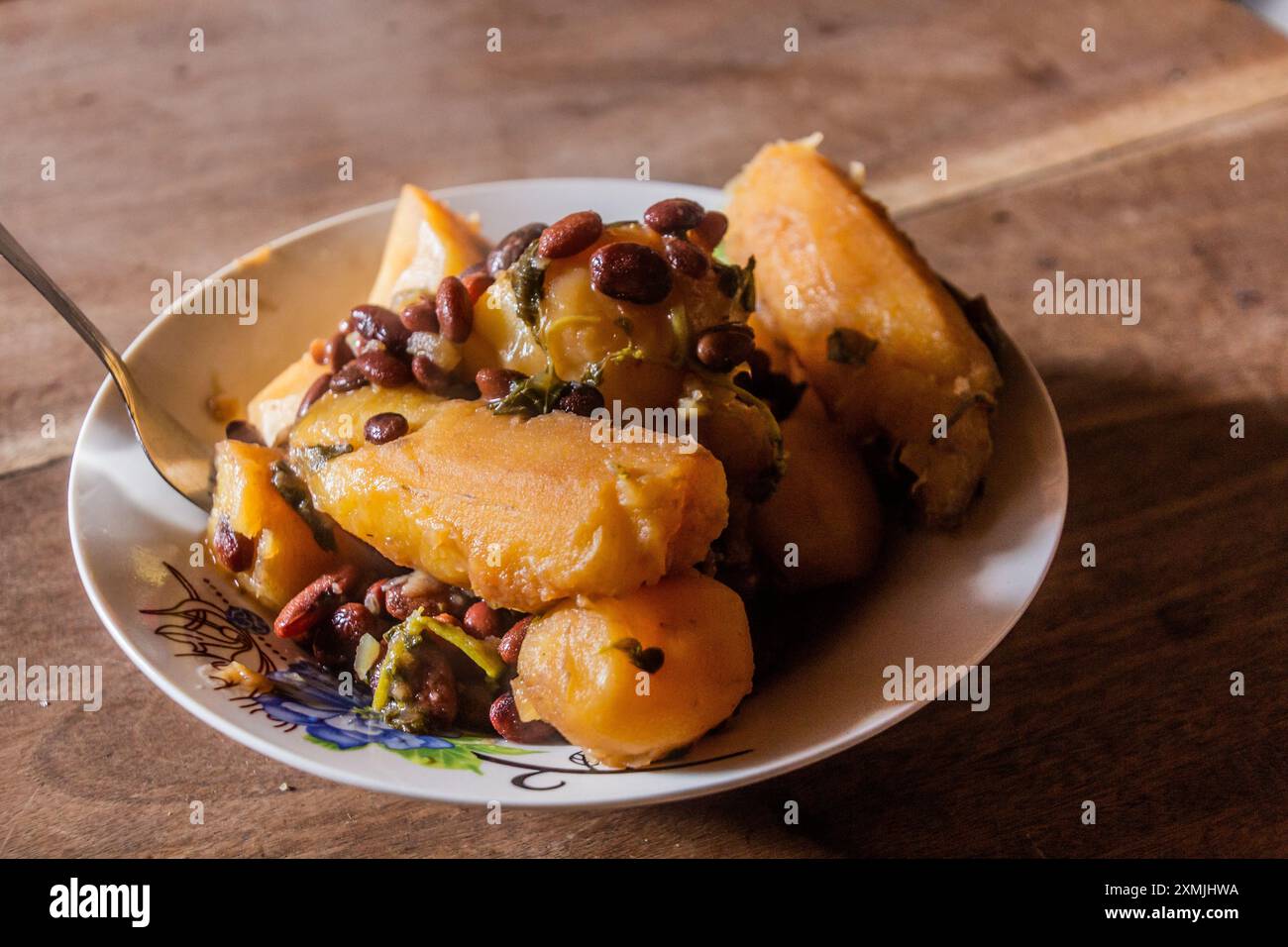 Meal in Uganda - matoke bananas with beans Stock Photo - Alamy