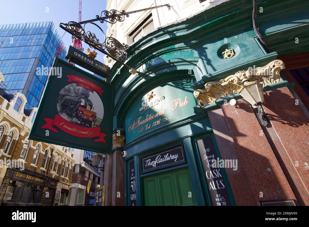 The Railway Tavern pub owned by Greene King sign on a sunny day. London ...