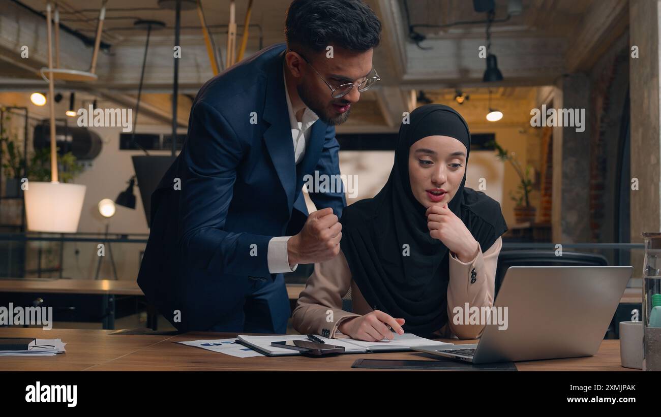 Muslim woman hijab female businesswoman student work laptop at office Arabian man male ...