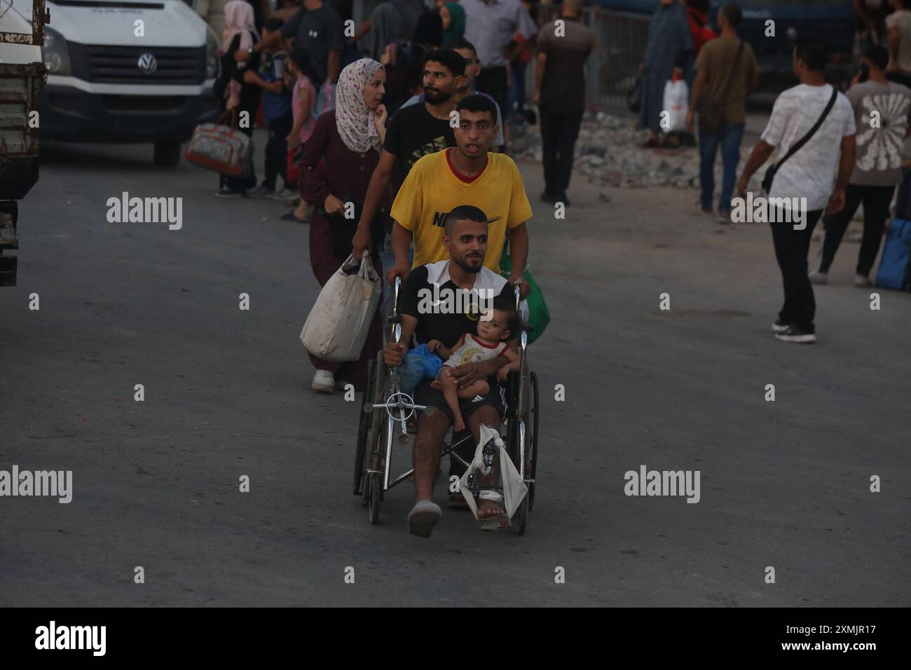 Palestinians carrying their personal belongings flee the al-Bureij ...