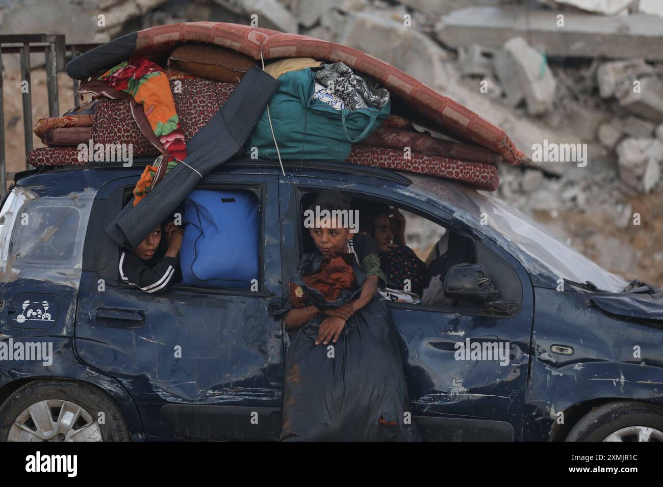 Palestinians carrying their personal belongings flee the al-Bureij ...