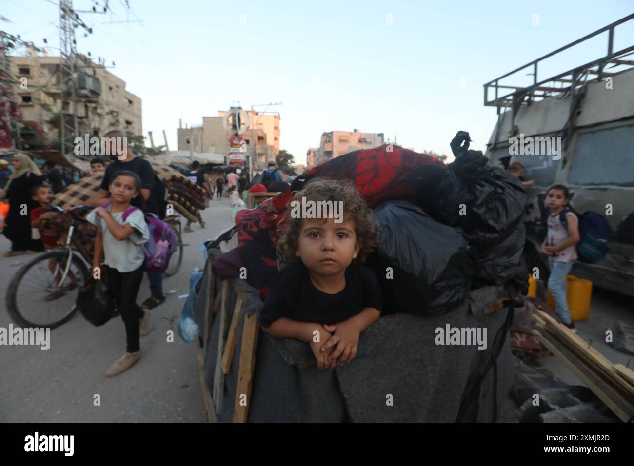 Palestinians carrying their personal belongings flee the al-Bureij ...