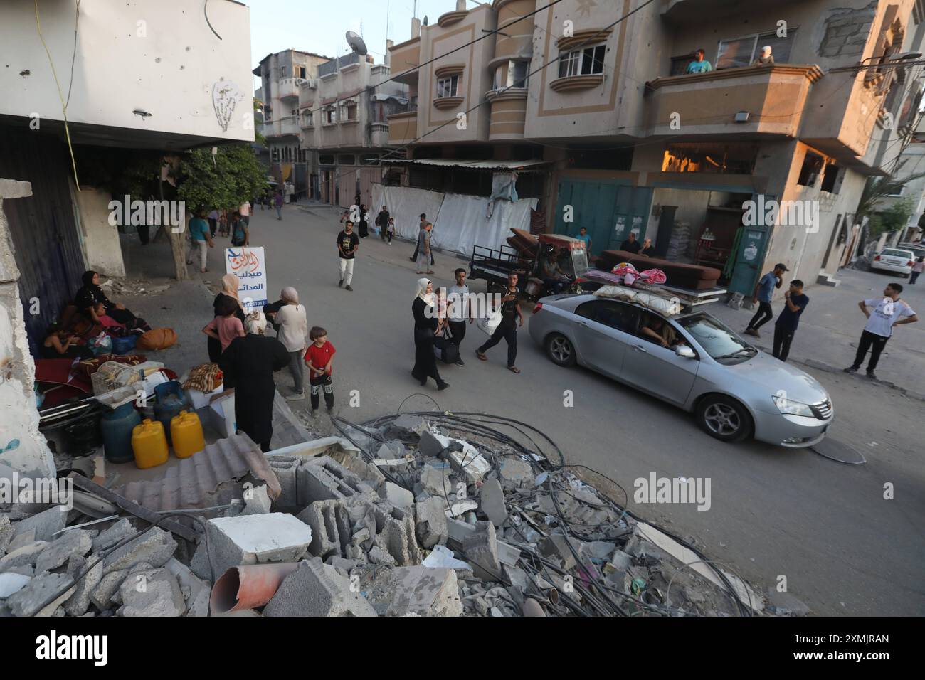 Palestinians carrying their personal belongings flee the al-Bureij ...