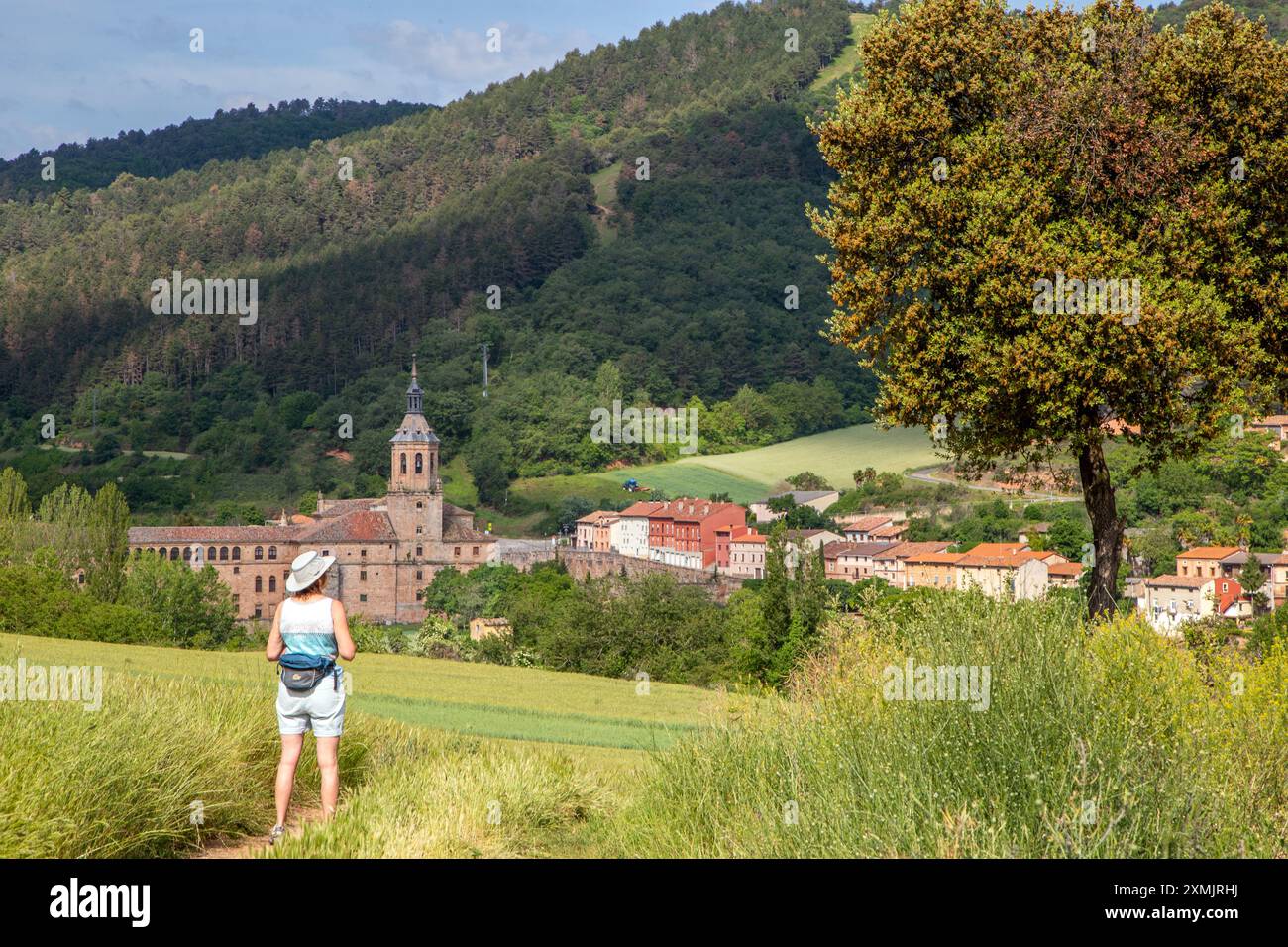 Woman walking towards the Monastery of San Millan de Yuso in the ...