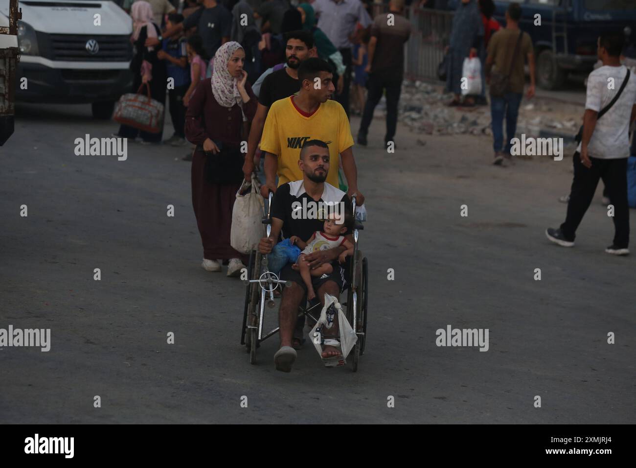 Palestinians carrying their personal belongings flee the al-Bureij ...